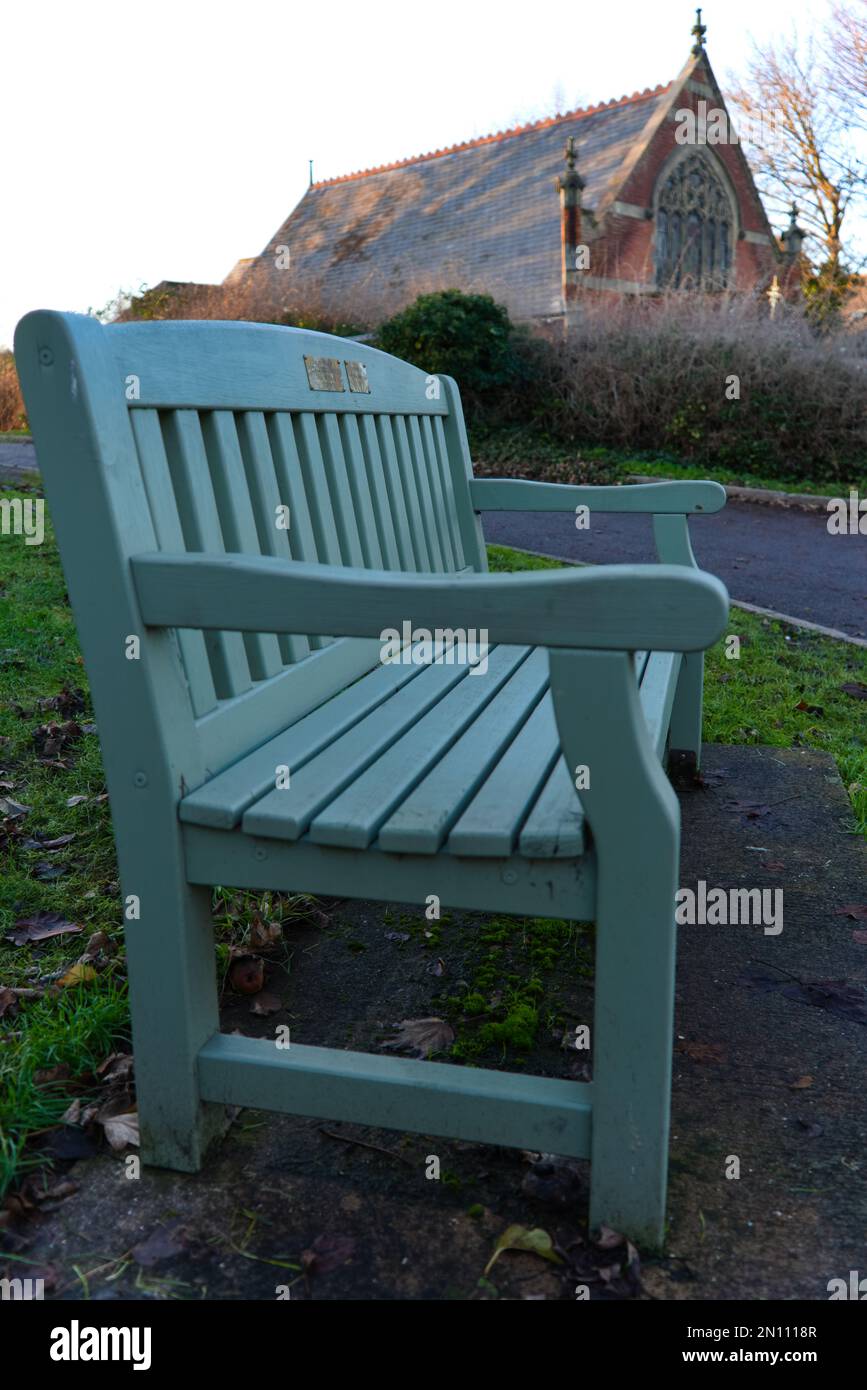 Green bench in front of Parish church in the background Stock Photo - Alamy