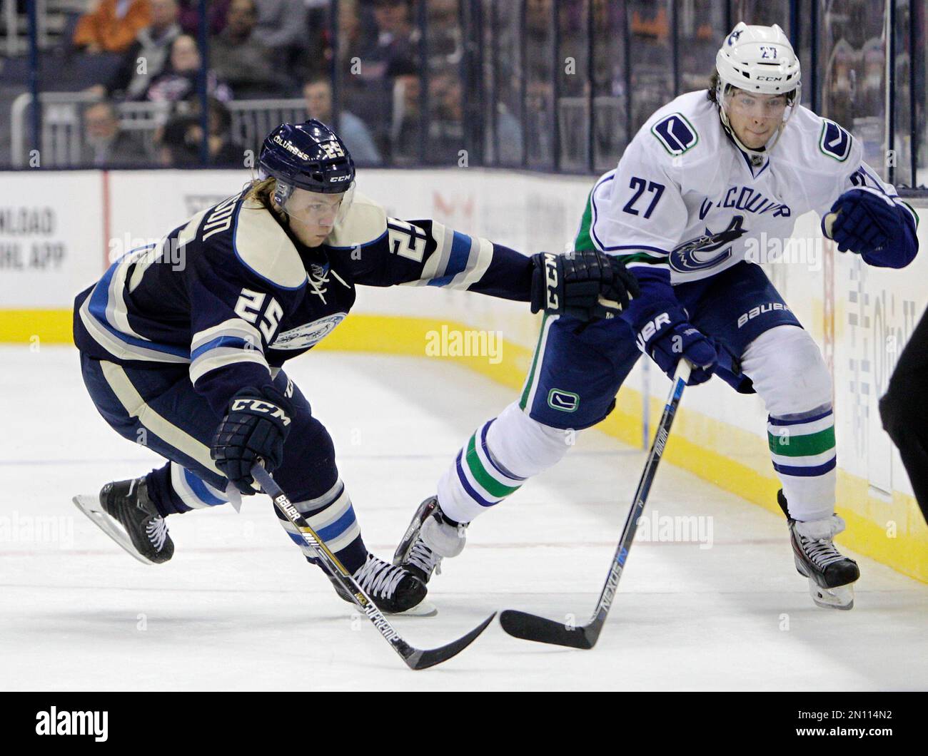 Vancouver Canucks' Ben Hutton, right, and Columbus Blue Jackets ...
