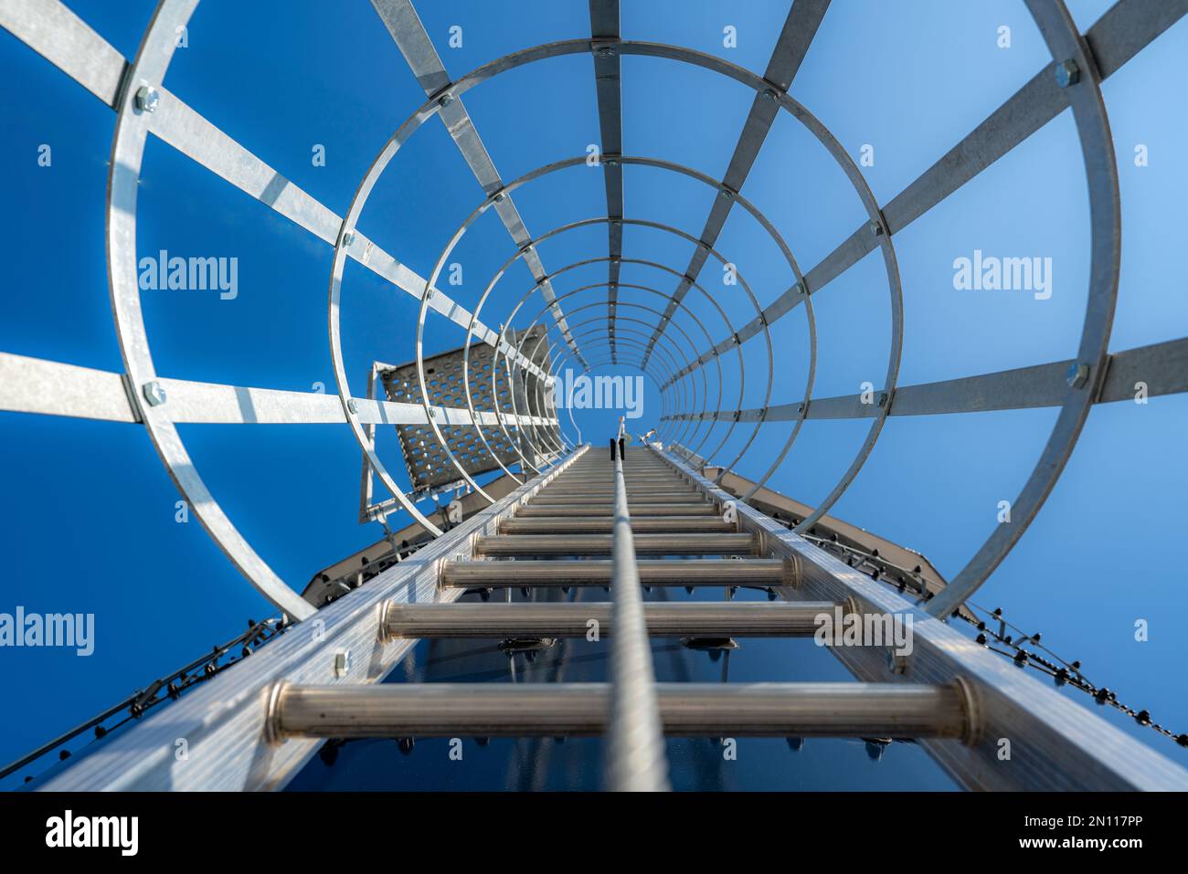 Vertical metal ladder with cage along the side of a water tank Stock ...