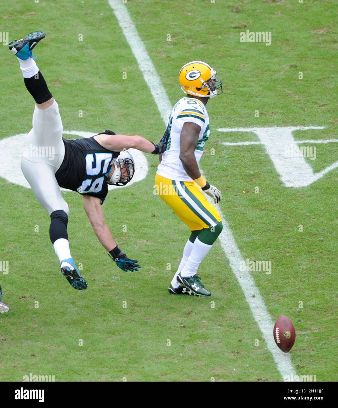 Carolina Panthers' Luke Kuechly (59) flips over as he defends a pass to ...