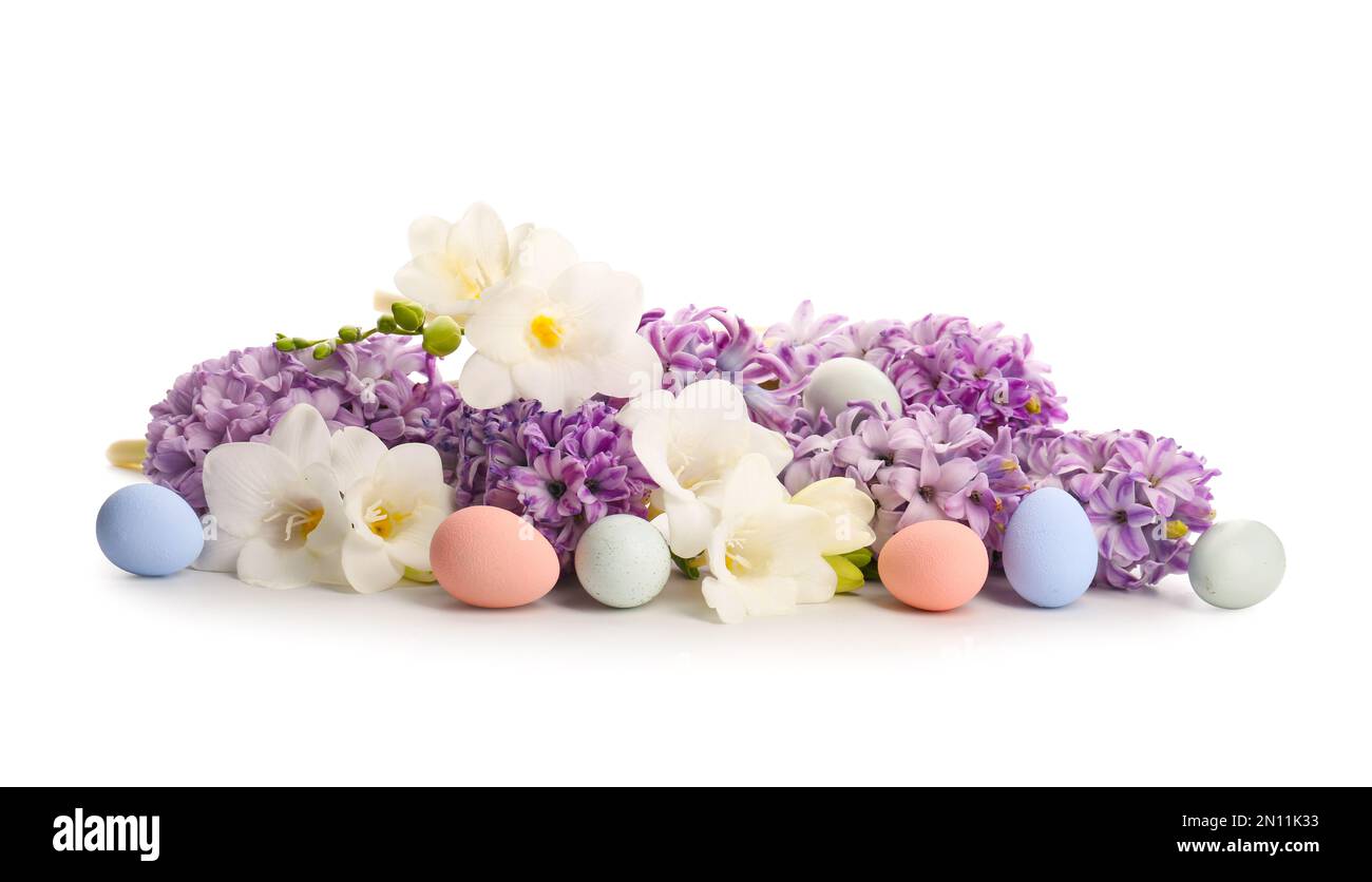 Composition with beautiful spring flowers and Easter eggs on white ...