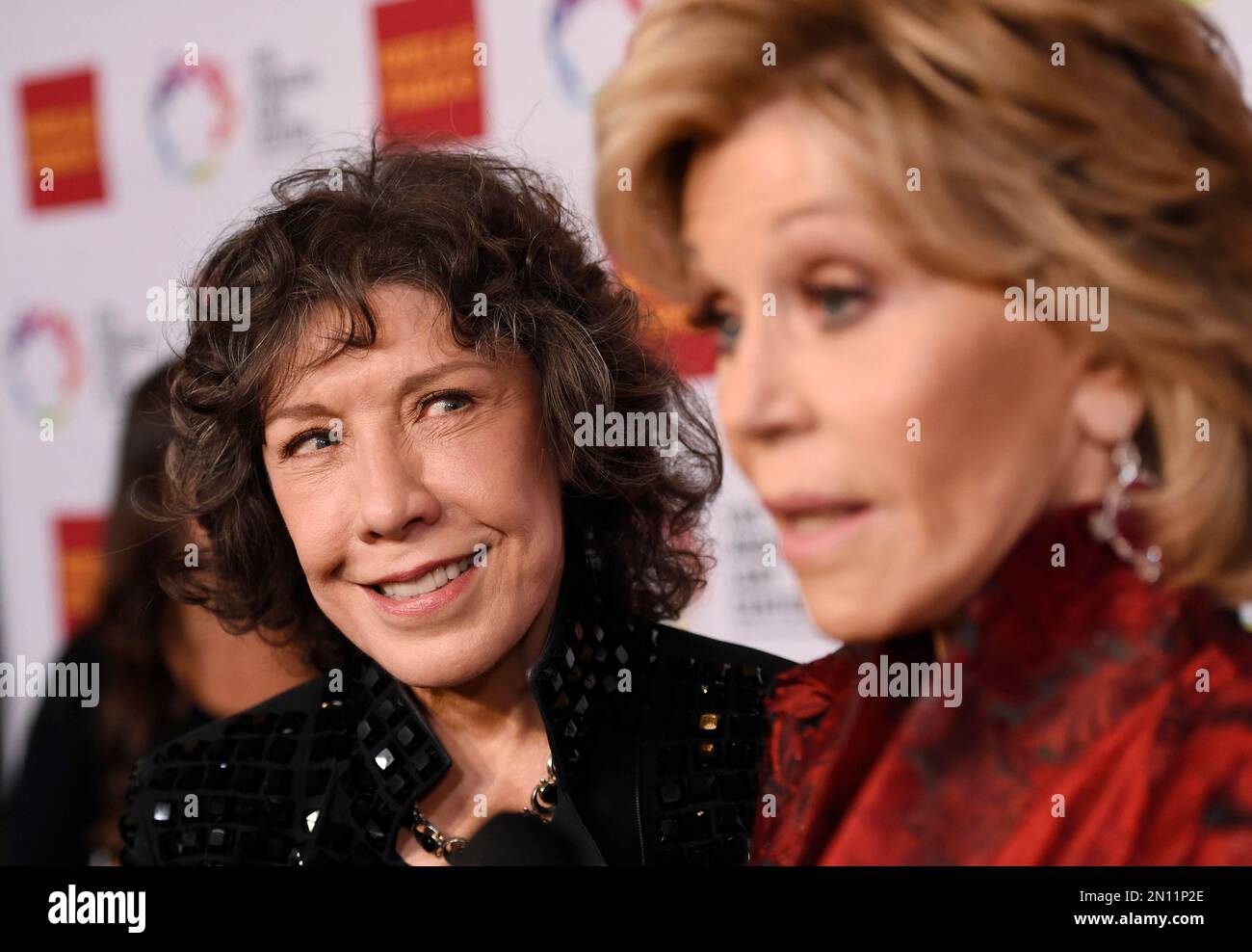 Presenter Lily Tomlin, left, looks on as honoree Jane Fonda is ...