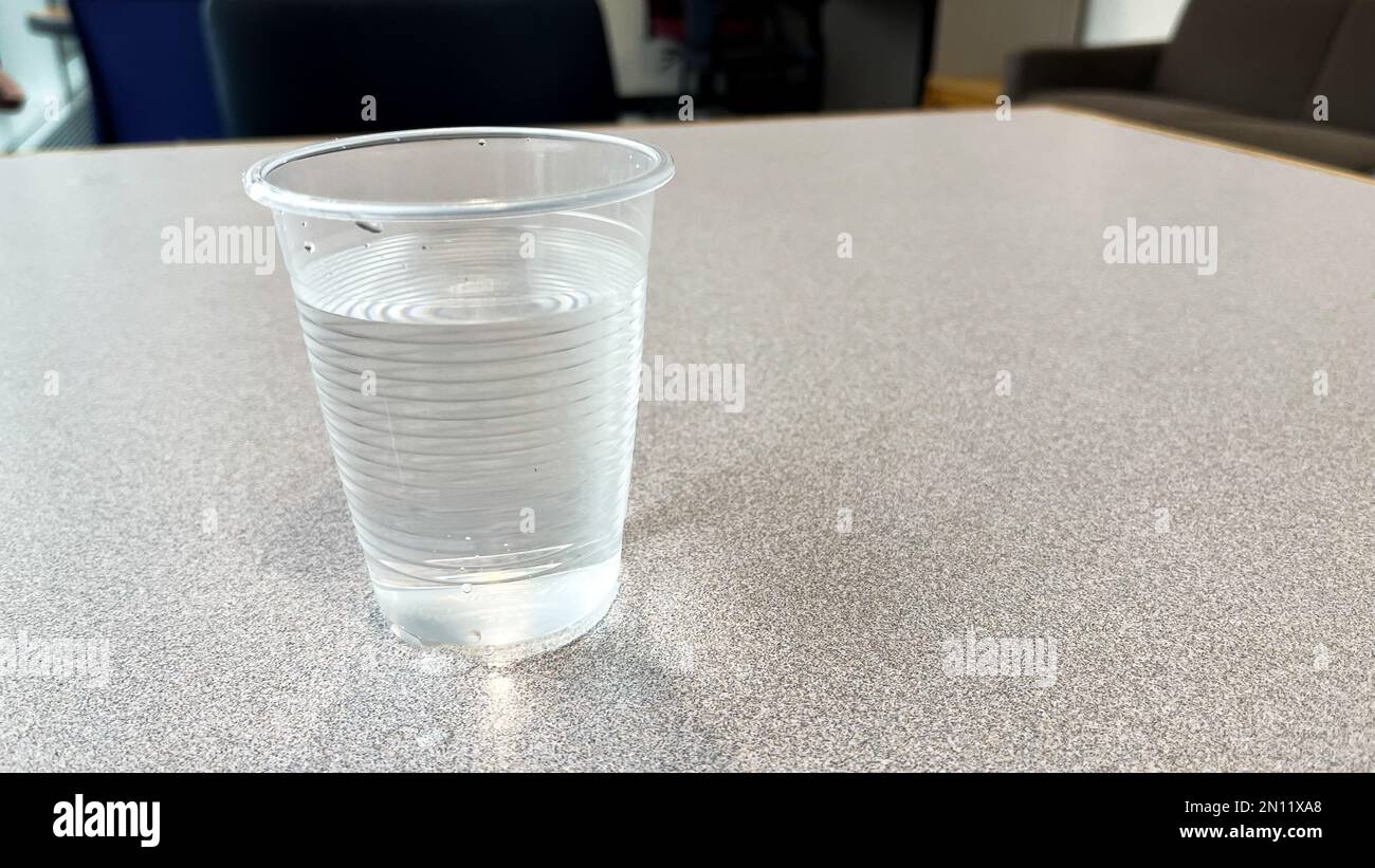 Plastic water cup on table clean recycle Stock Photo - Alamy