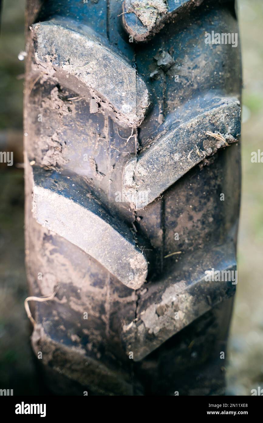 Volumetric rubber tread on a tractor wheel close-up. Mud tire pattern ...