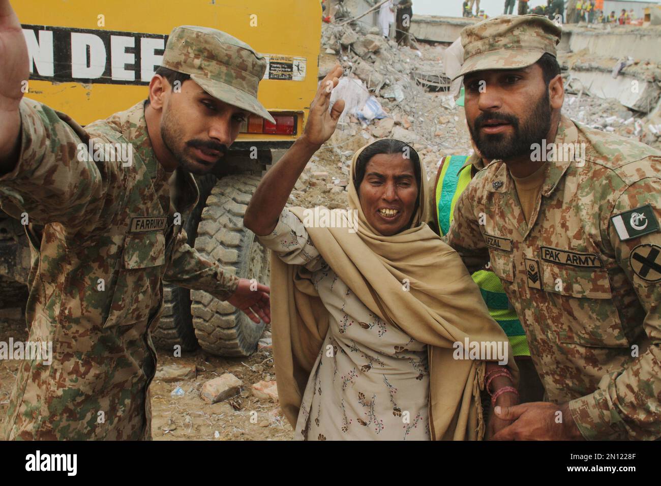 Pakistani army soldiers comfort a mother crying for her missing son in ...