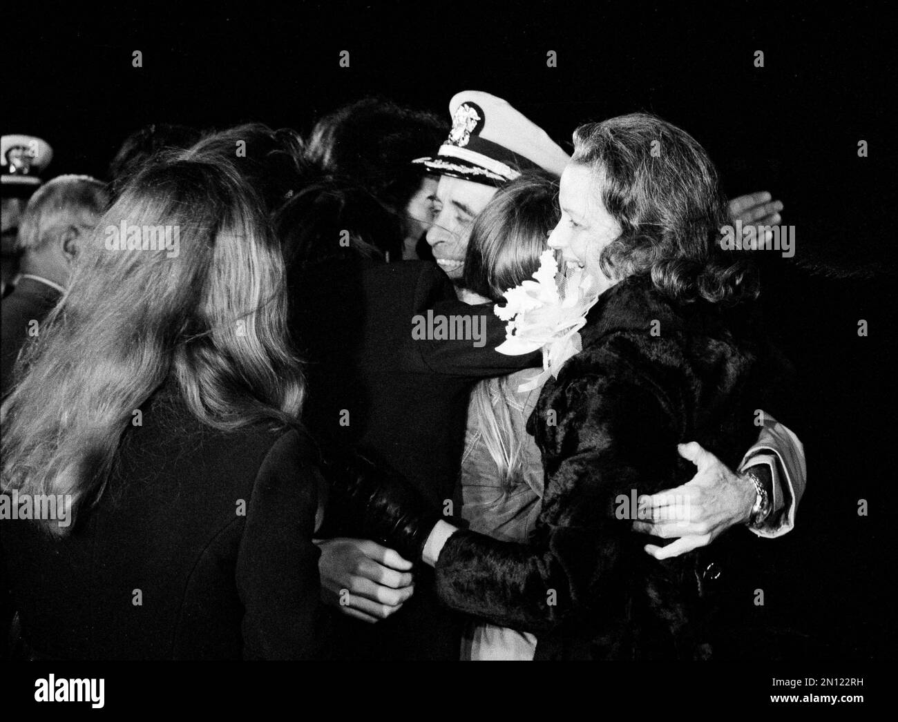 Capt. Jeremiah Denton Jr., USN, is hugged by his wife Jane and children ...