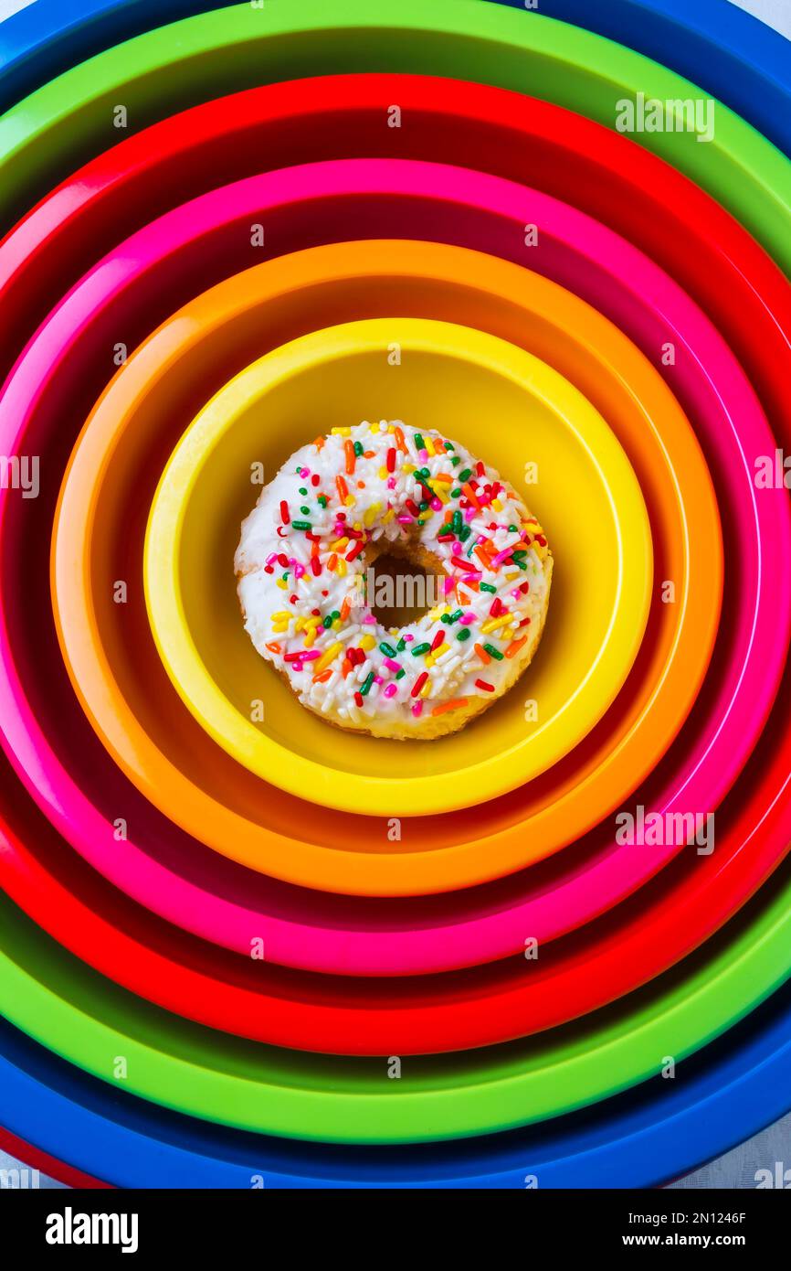 Colored Bowls And Donut Stock Photo - Alamy