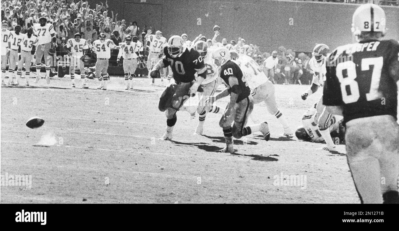 Oakland Raiders players in black lead the chase for the ball in San ...