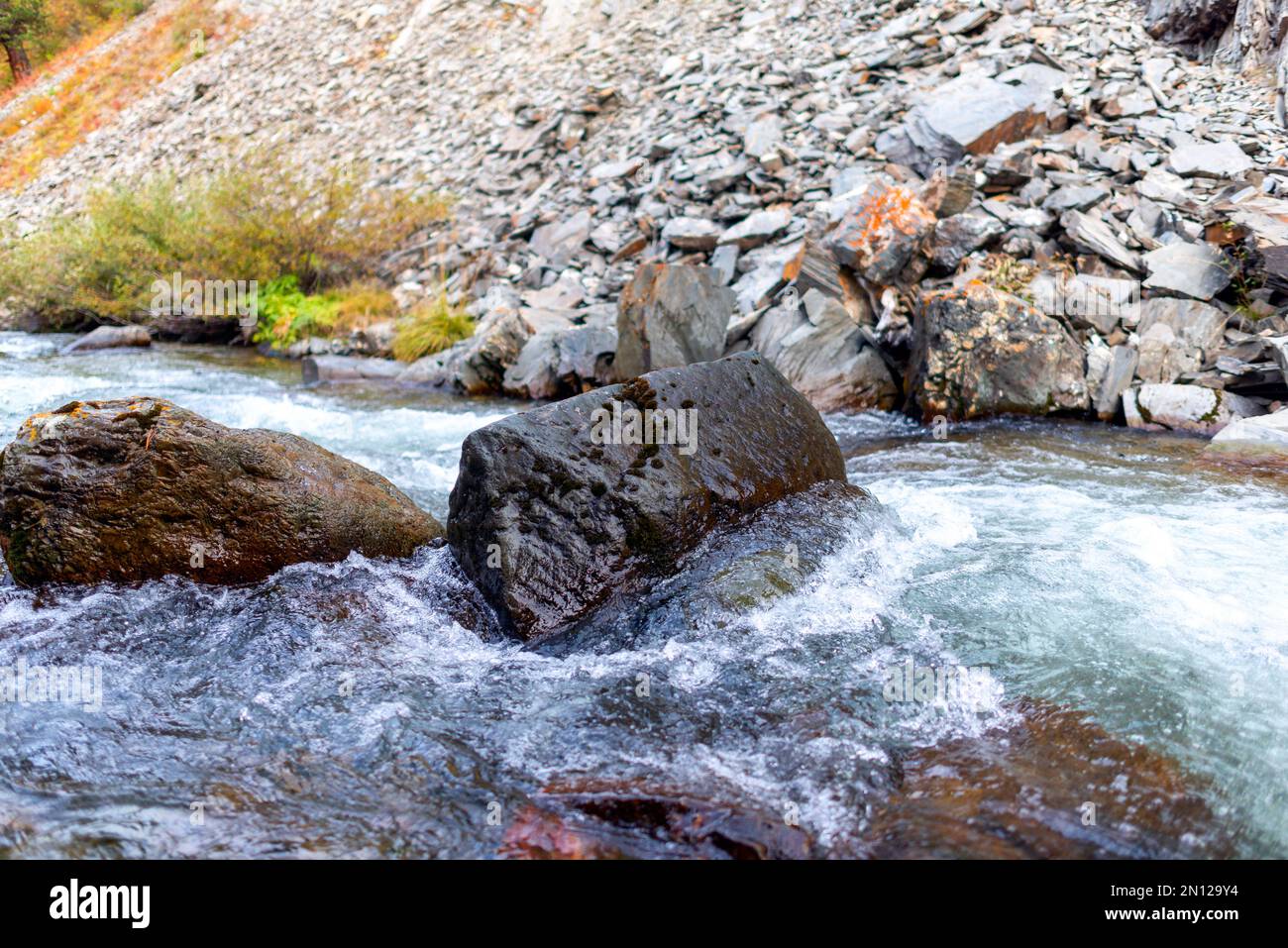 The rapid flow of a mountain river among the stones of rocks Stock ...