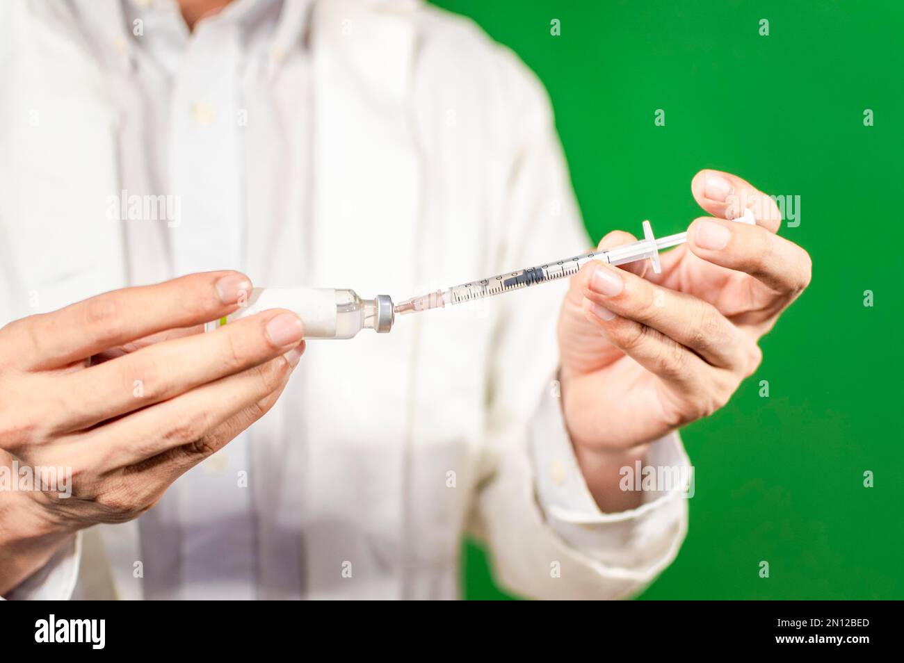 Close up of hands with syringes and capsule, syringe cure concept ...