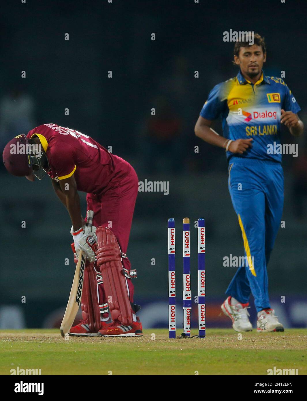 West Indies' Jonathan Carter, left, reacts as he is bowled out by Sri ...