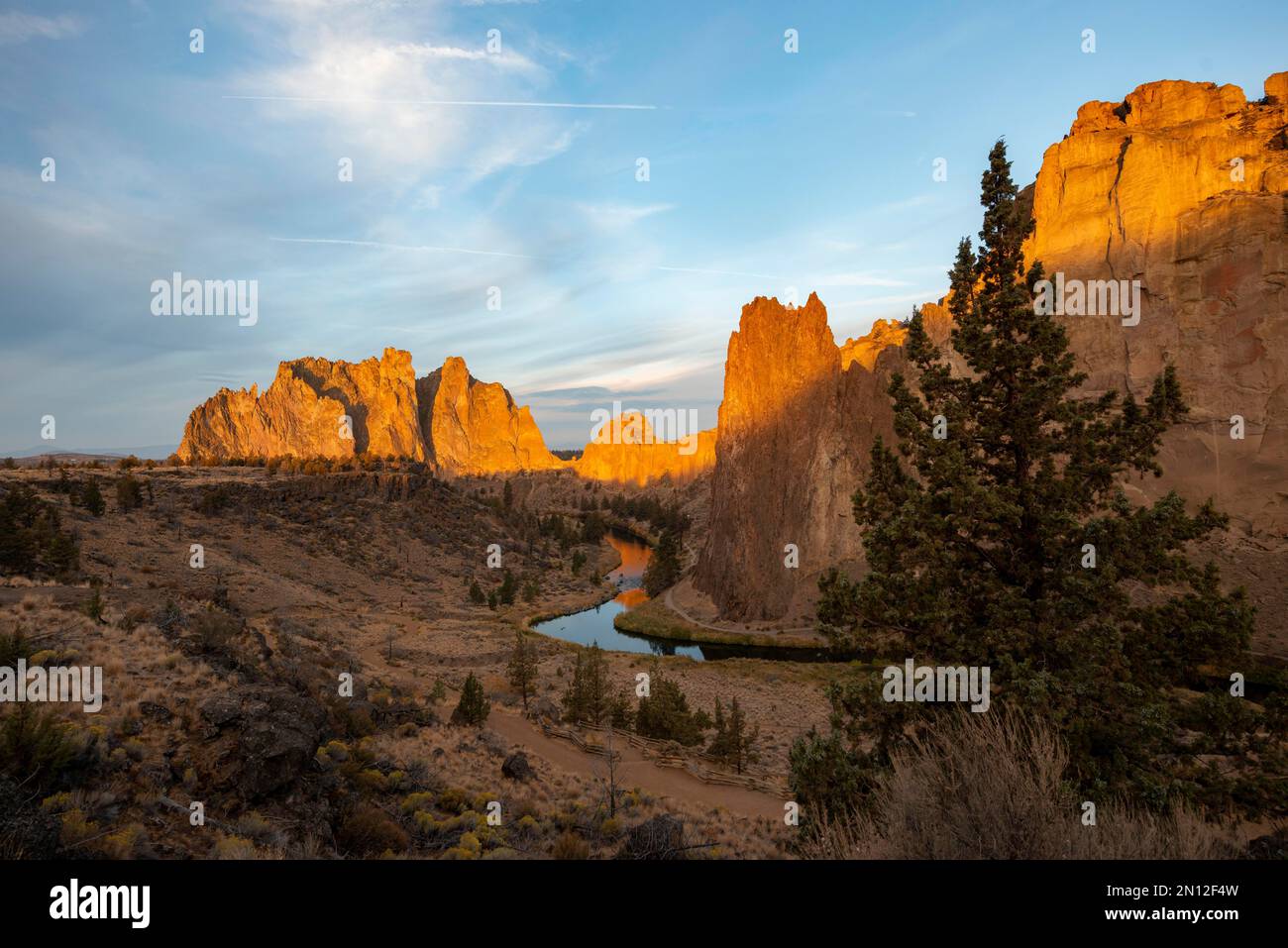 Red rock walls at sunrise, course of the Crooked River, canyon with ...