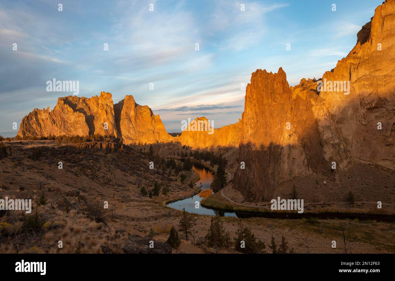 Red rock walls at sunrise, course of the Crooked River, canyon with ...