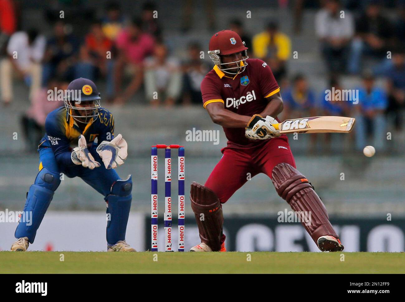 West Indies' Johnson Charles plays a shot in front of Sri Lanka's ...