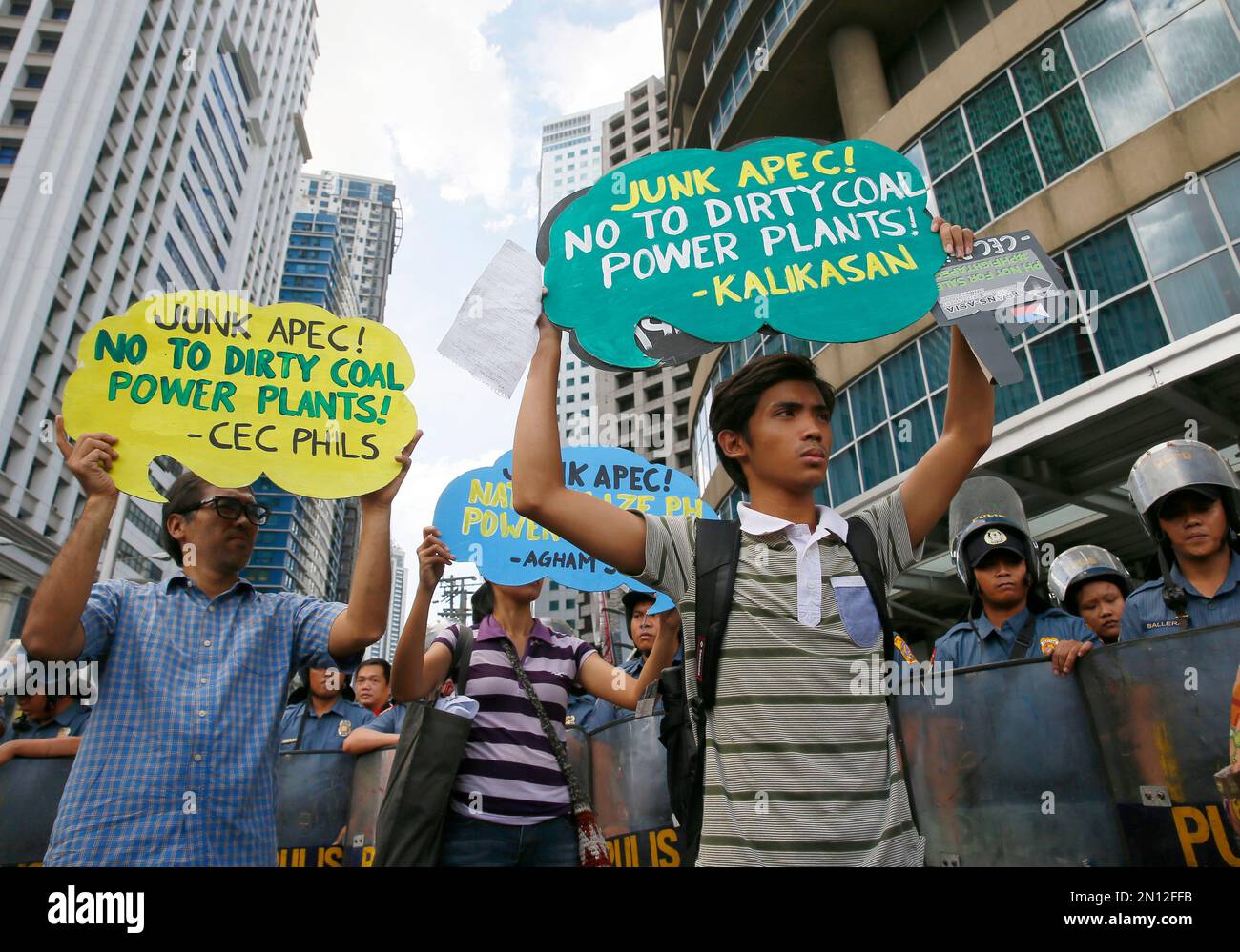 Environmental activists display placards as they picket the venue of ...