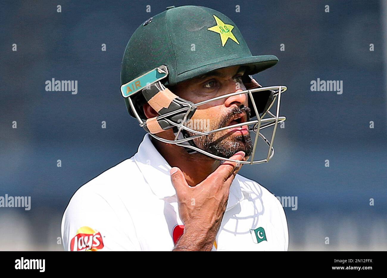 Pakistan's batsman Muhammed Hafeez leaves the pitch after he was ...