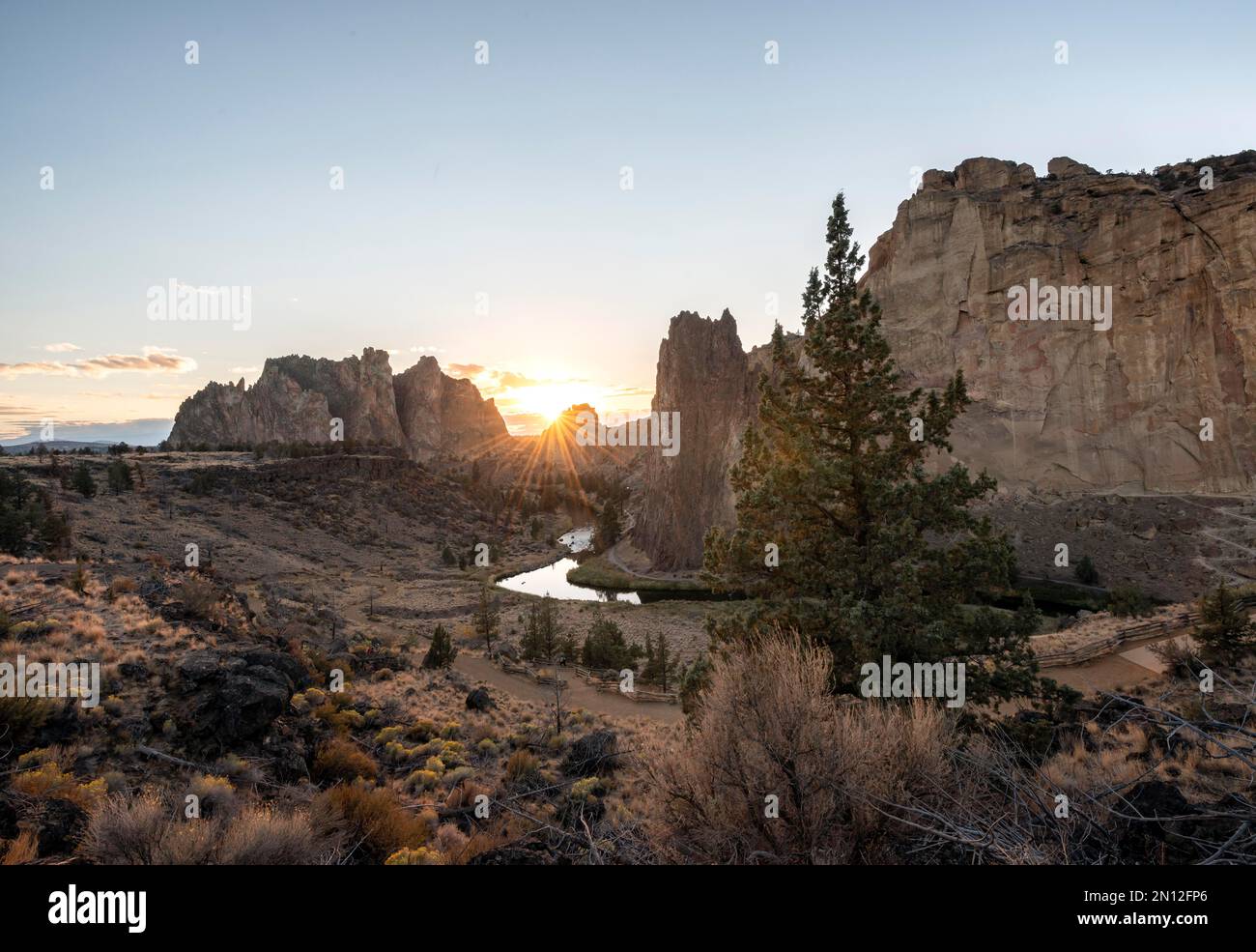 Sun star on rock walls, sunset, river course of the Crooked River ...