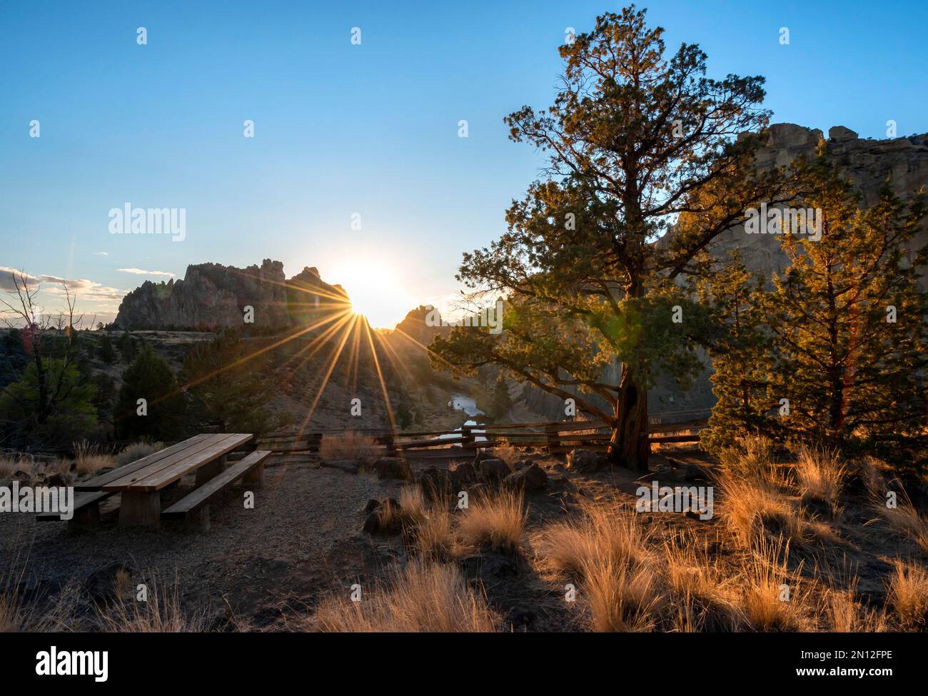 Bench and table at viewpoint, sun star on rock walls, sunset, course of ...