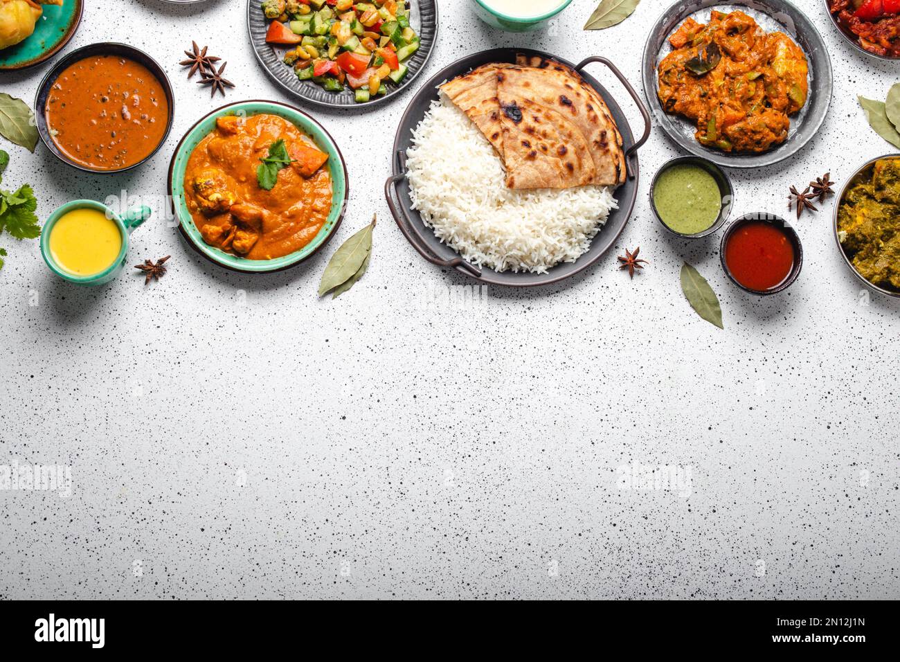 Indian ethnic food buffet on white concrete table top view: curry ...