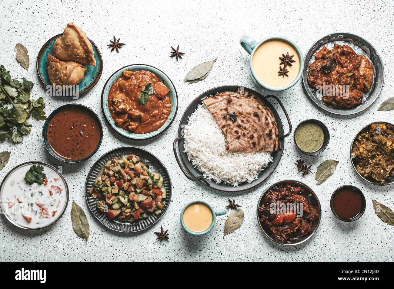 Indian ethnic food buffet on white concrete table from above: curry ...