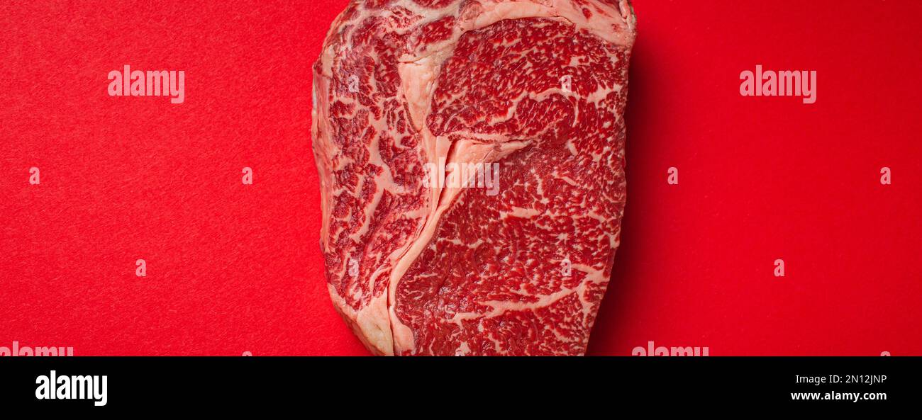 Raw fresh uncooked meat beef prime cut steak Ribeye on clean red ...