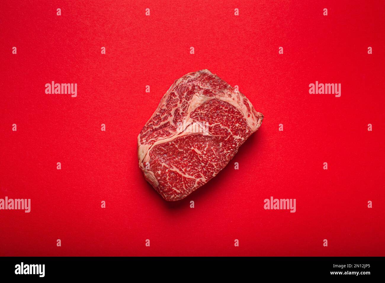 Raw fresh uncooked meat beef prime cut steak Ribeye on clean red ...