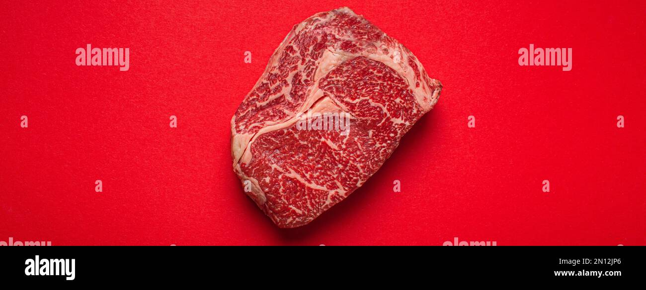Raw fresh uncooked meat beef prime cut steak Ribeye on clean red ...