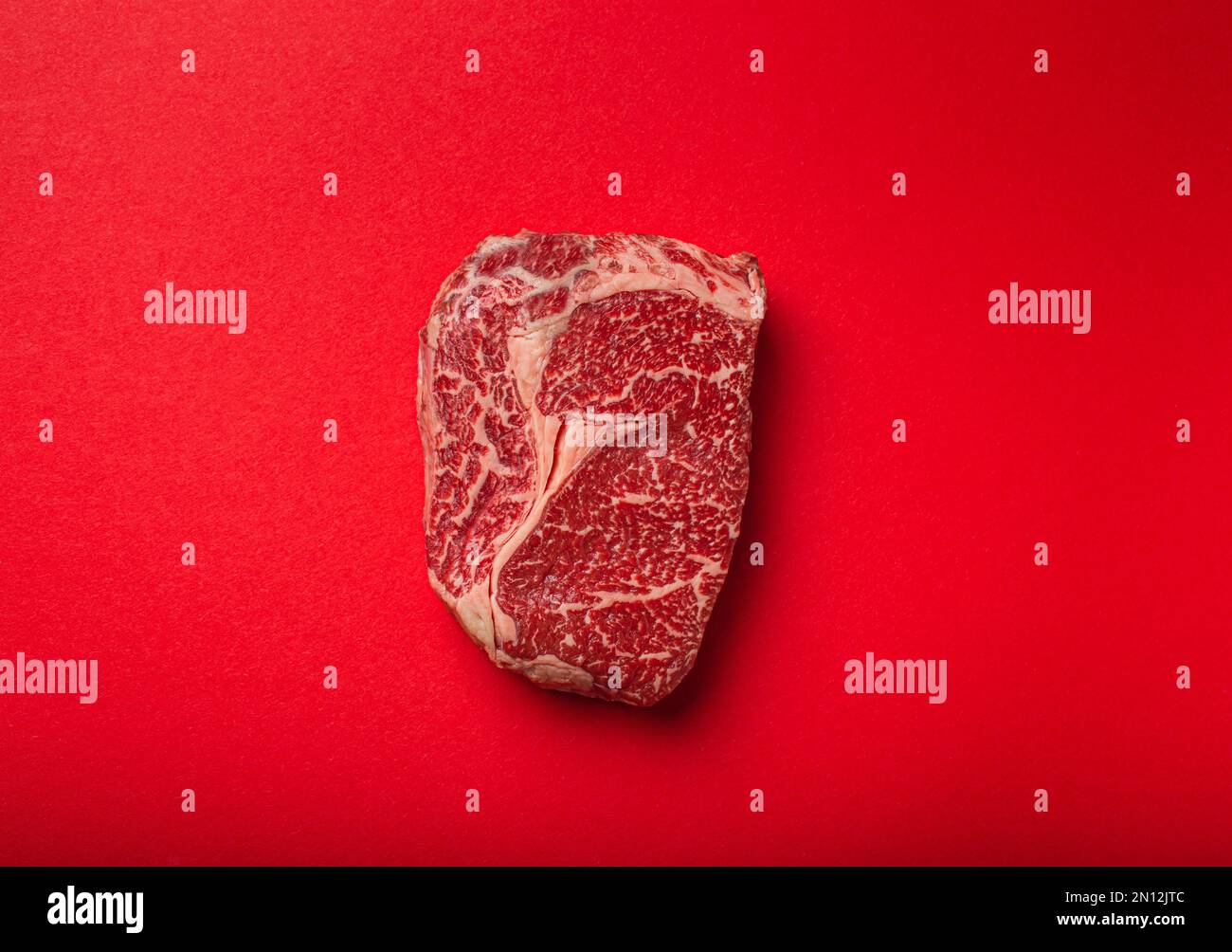 Raw fresh uncooked meat beef prime cut steak Ribeye on clean red ...