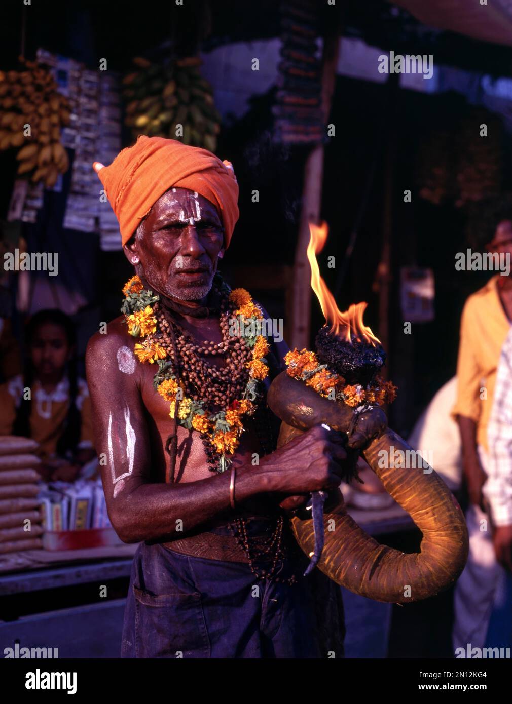 A devotee holding fire torch, discharging vow in Ranganatha temple at ...