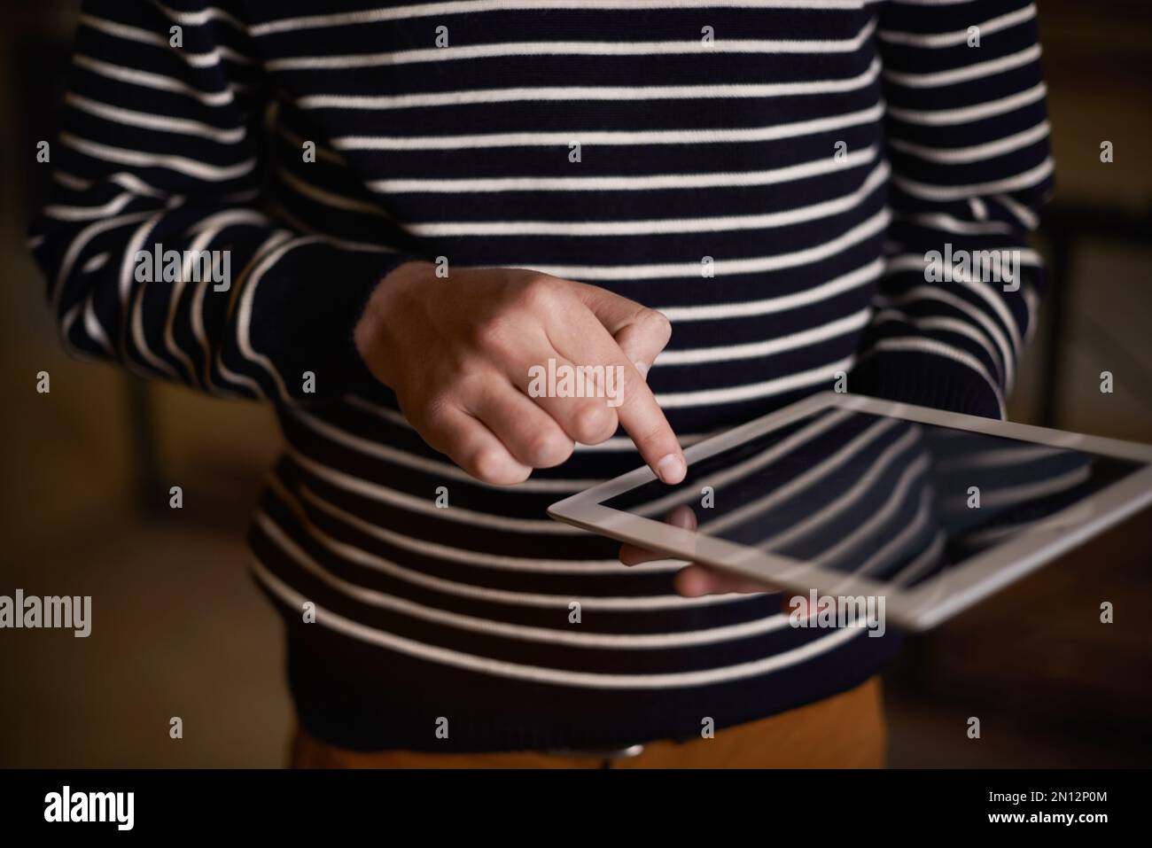 Using touchscreen technology. a hipster using a touchscreen device ...