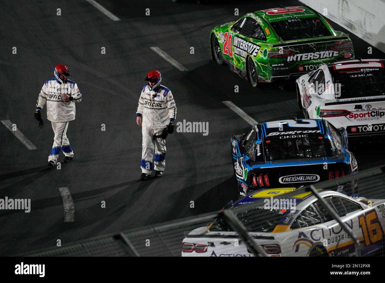 Crews look at the track after a crash during a NASCAR exhibition auto ...