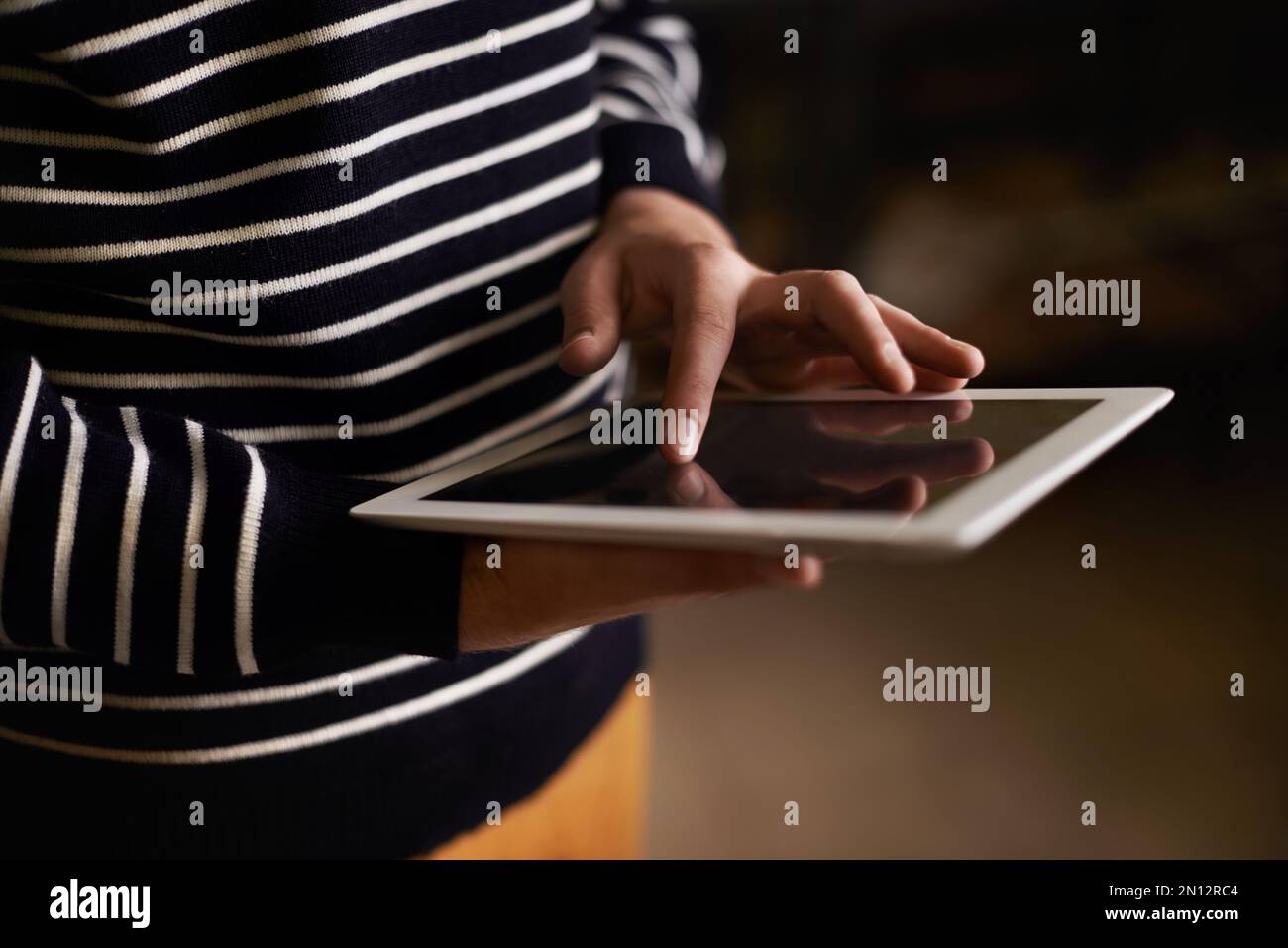 Using touchscreen technology. a hipster using a touchscreen device ...