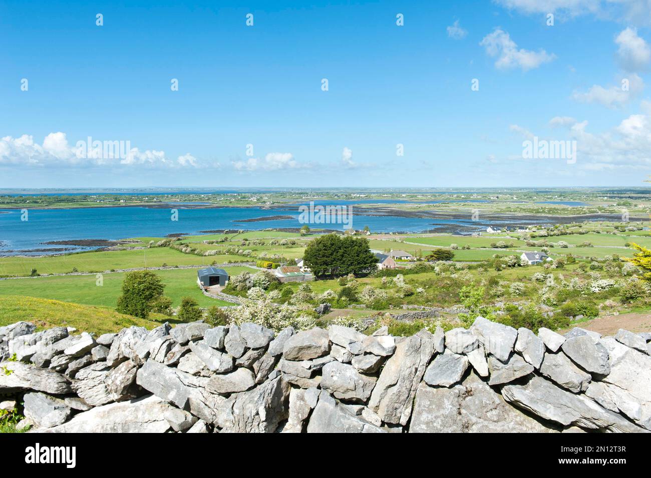Stone wall, karst landscape of The Burren in transition to the coastal ...