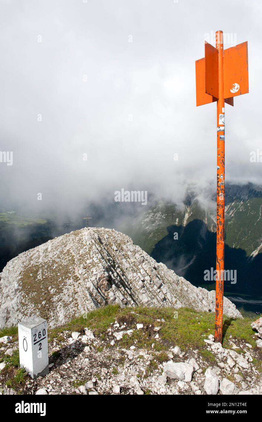 Summit, boundary stone and orange pole, line of the border across the ...