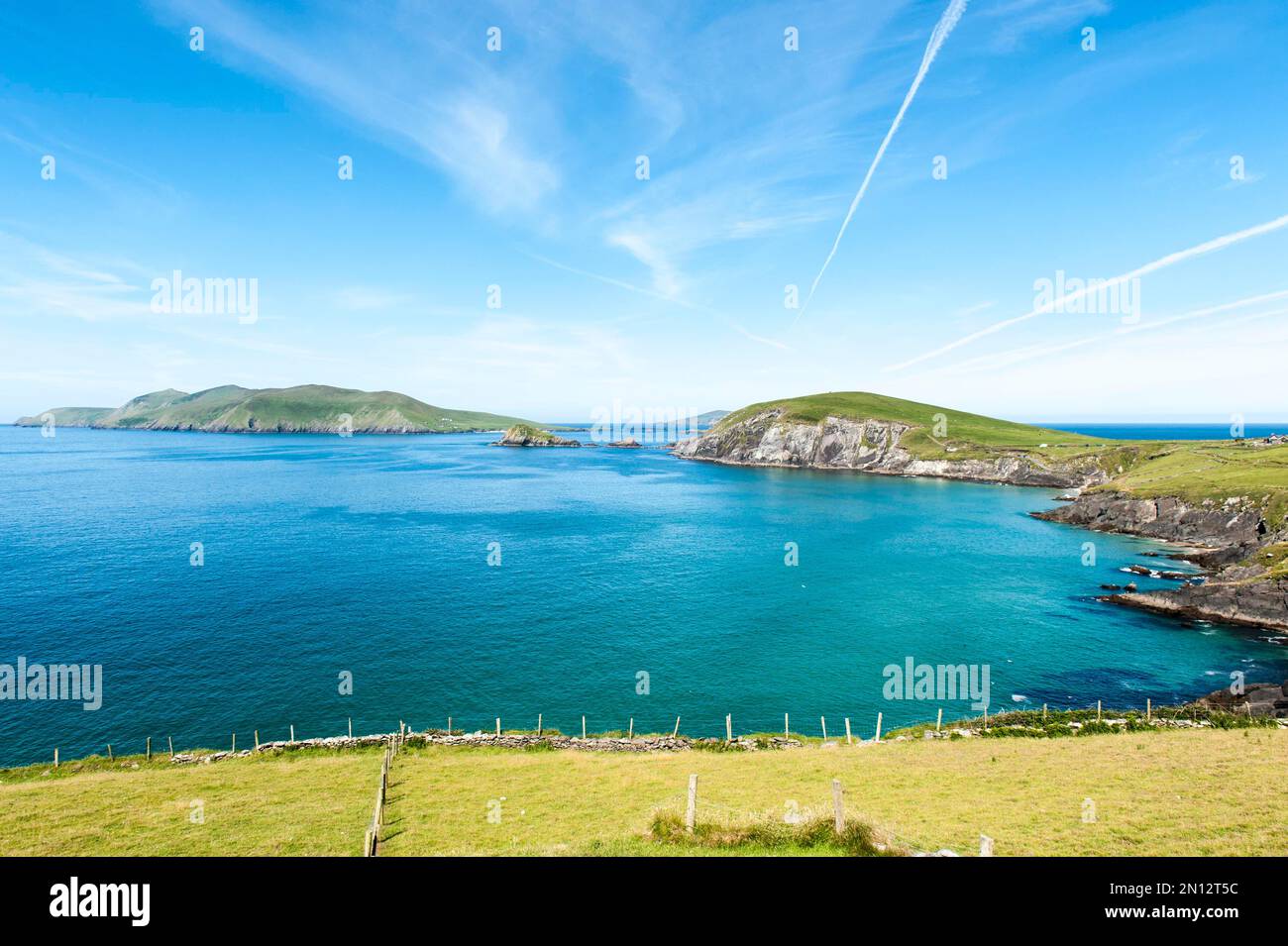 View of green coastal landscape with Blasket Islands behind left ...