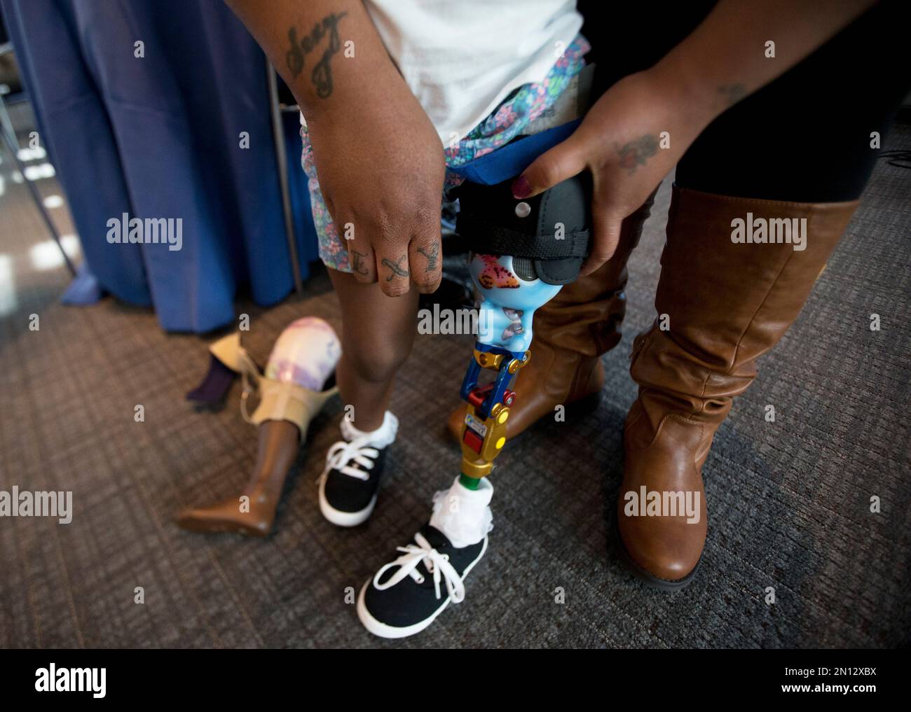 Tamara Williams, adjusts her 3-year-old daughter Miyah Williams ...
