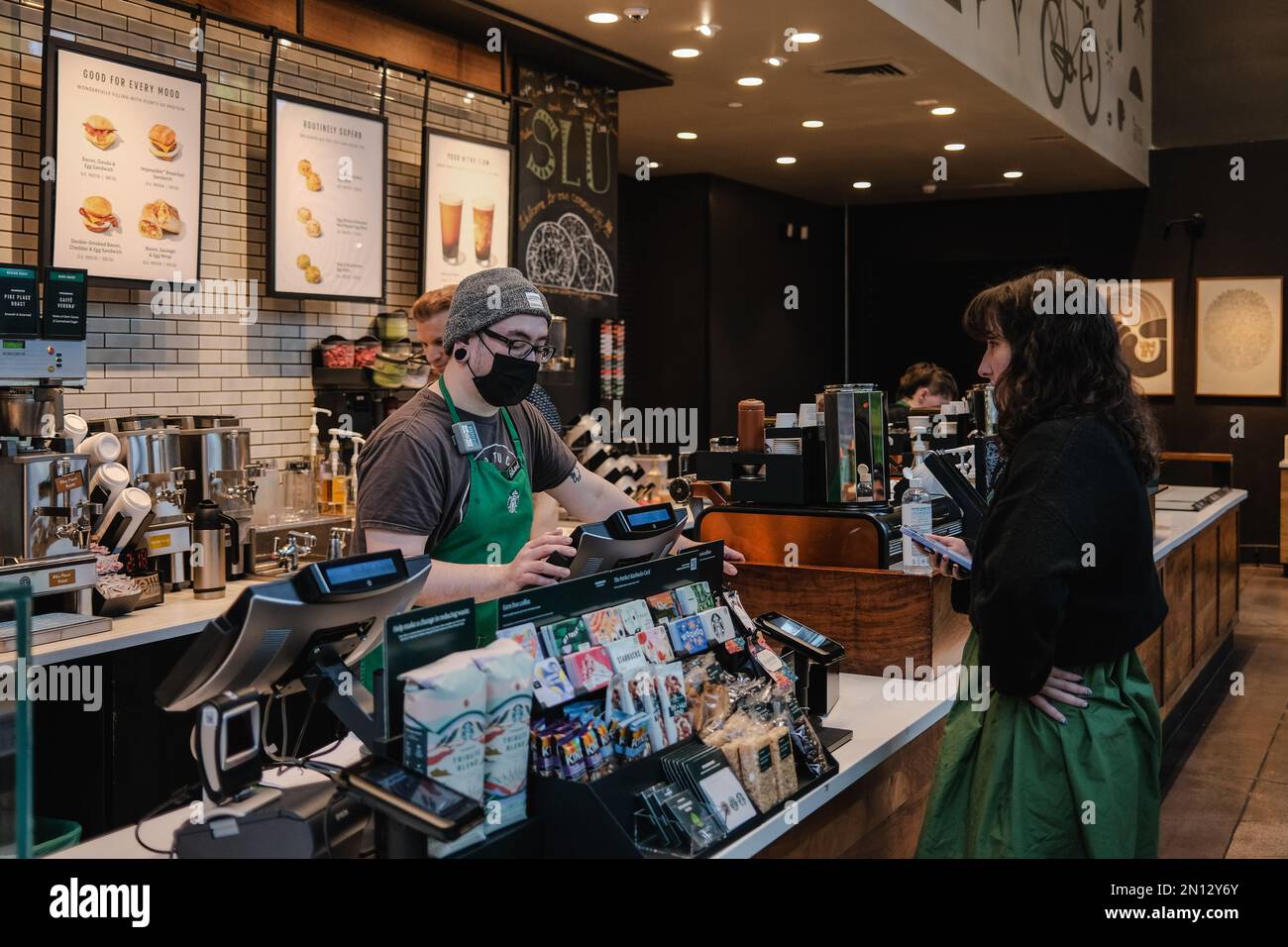 A customer buys a drink inside the Starbucks Seattle downtown store ...
