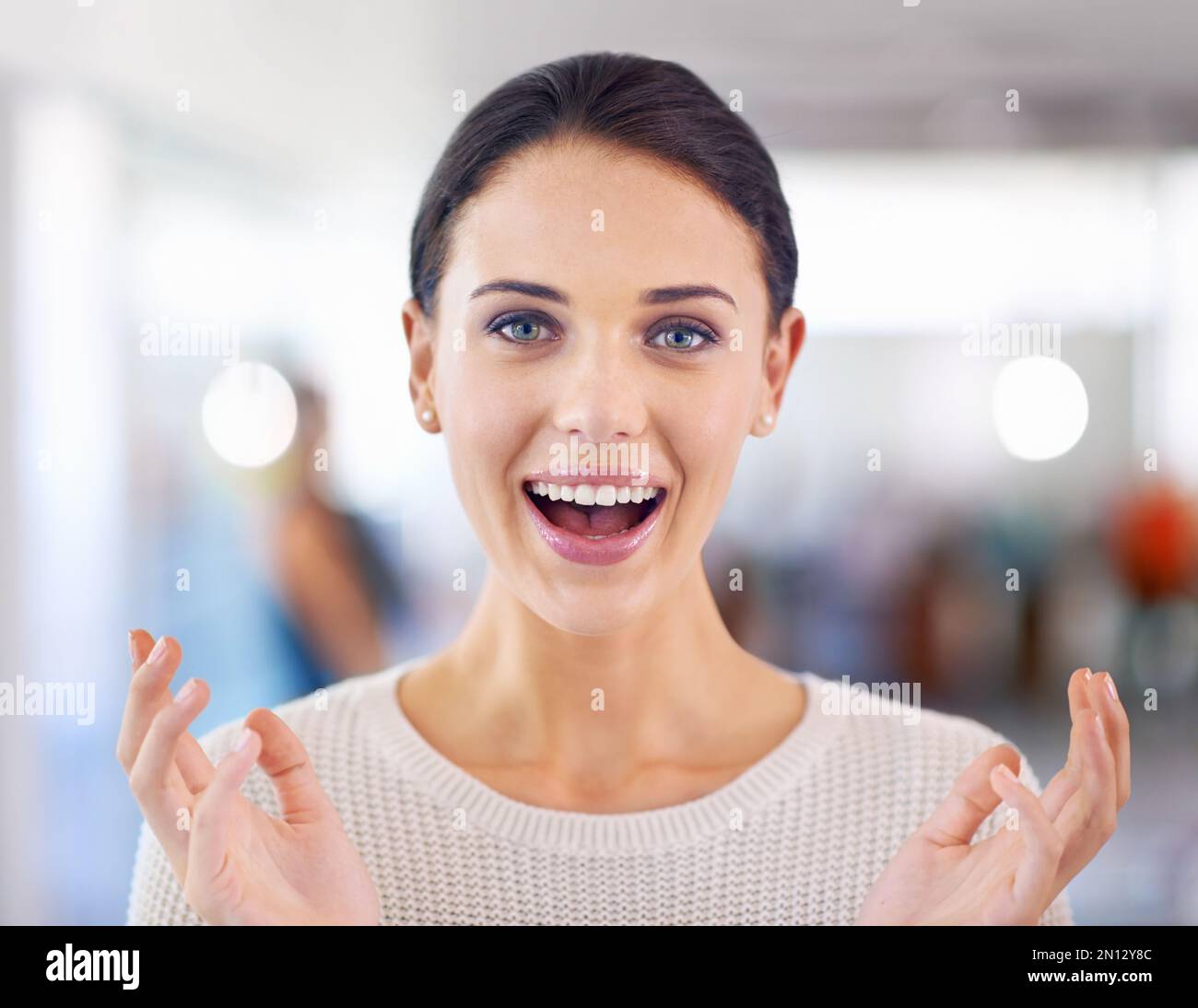 Thats great news. Head and shoulder view of a happy brunette woman ...