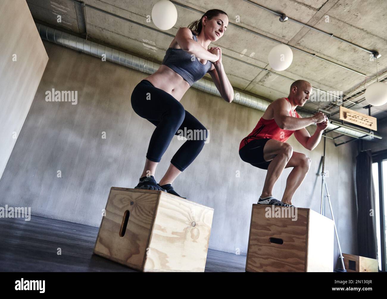 Turning up the intensity. two people doing a challenging workout at the ...