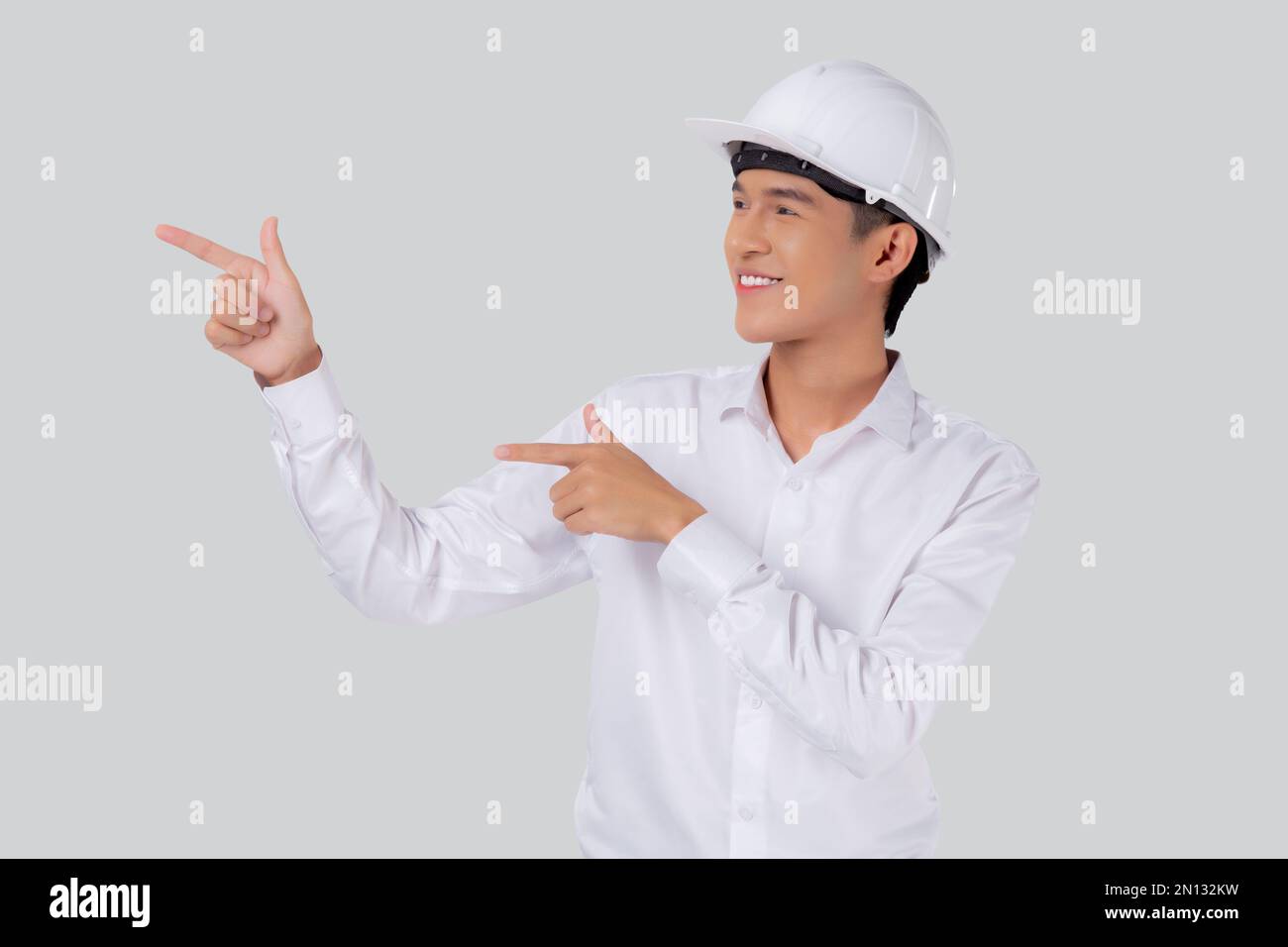 Portrait young asian man is engineer wearing helmet standing and ...