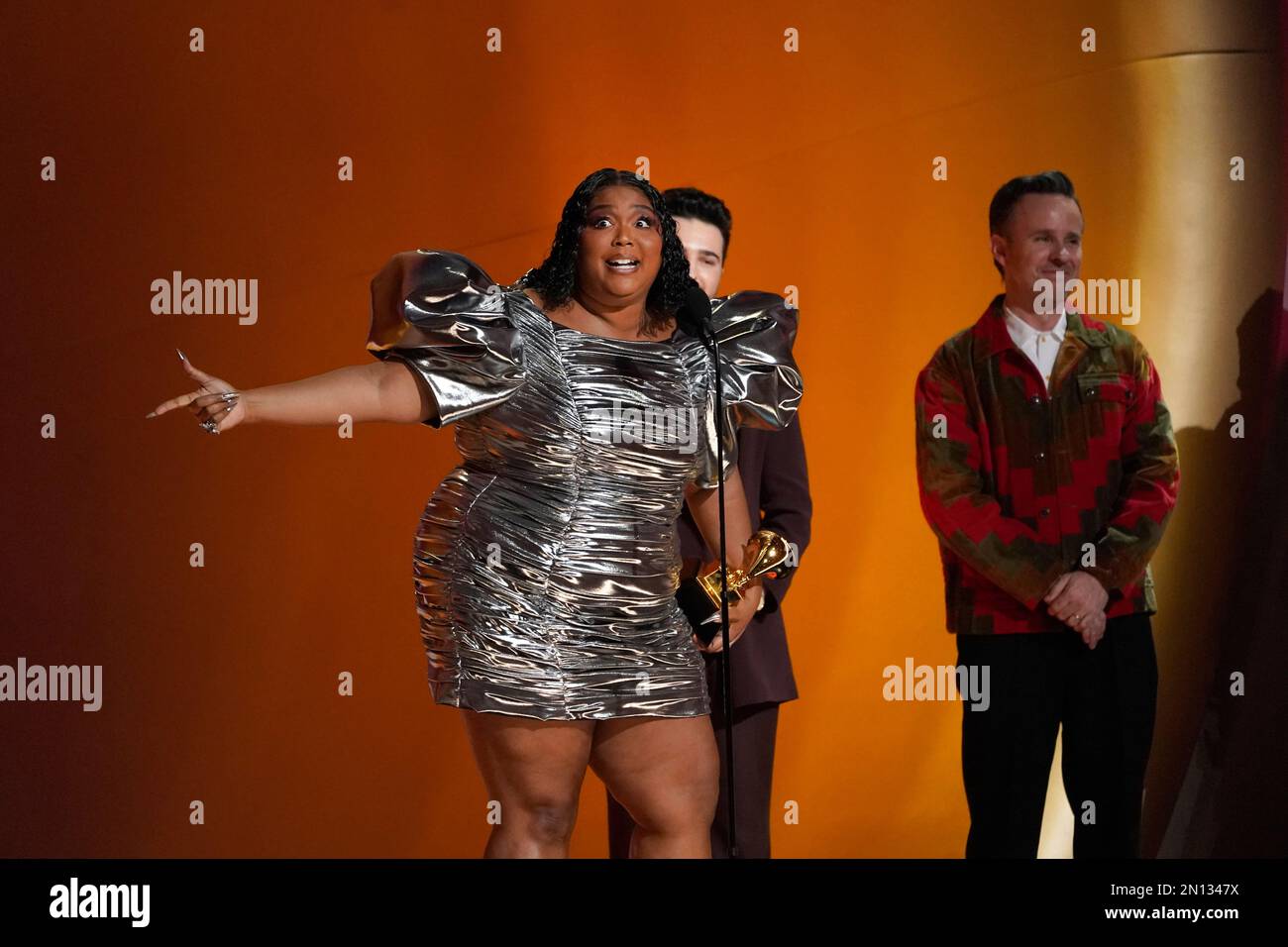Lizzo, center, accepts the award for record of the year for "About Damn ...