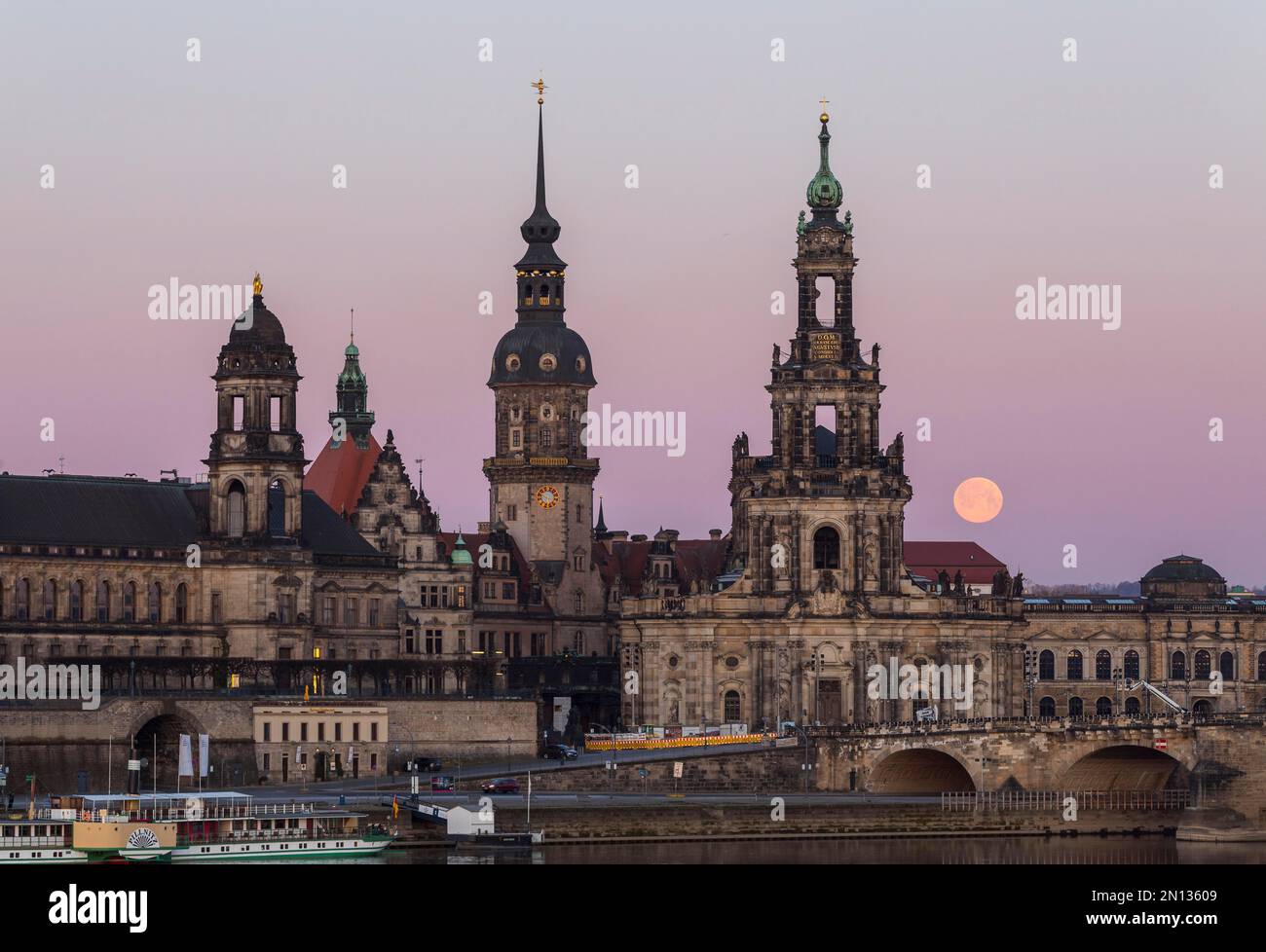Full moon behind the silhouette of the old town with the towers of the ...