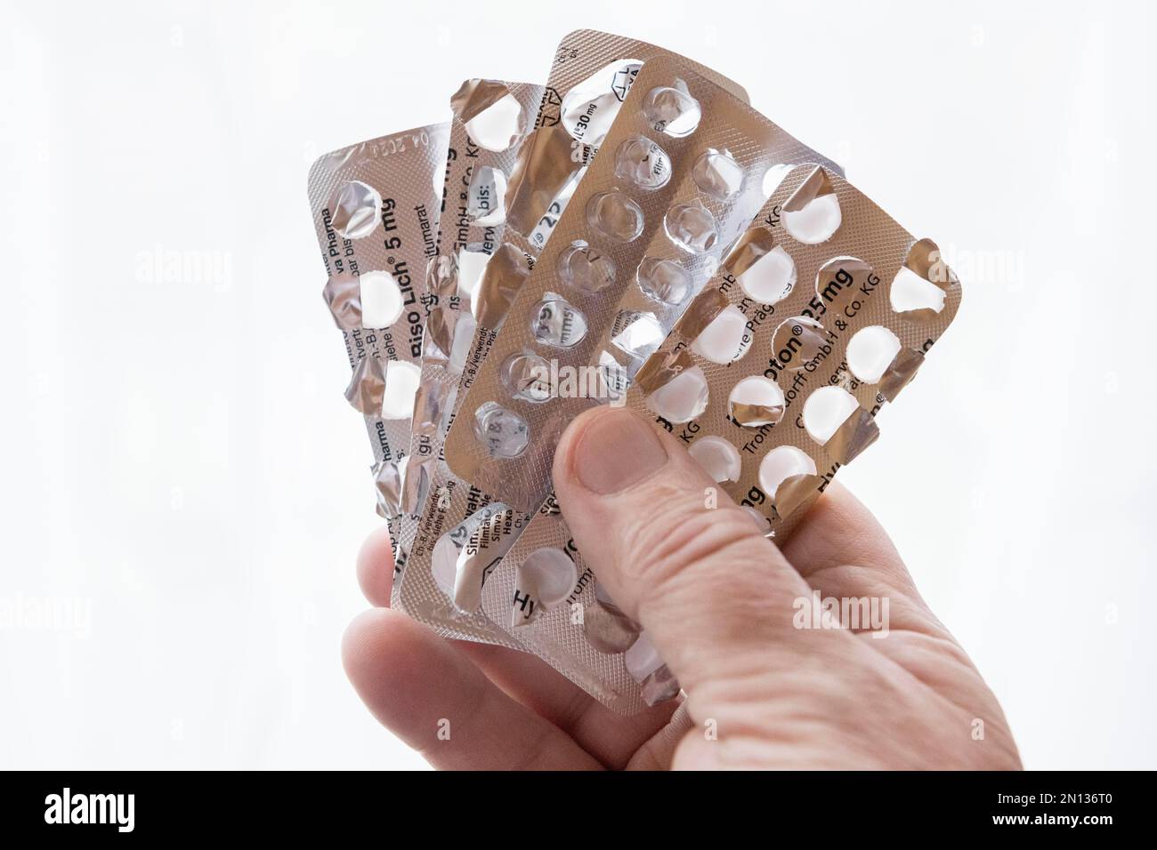 Hand holding blister packs of tablets, tablet addiction Stock Photo - Alamy