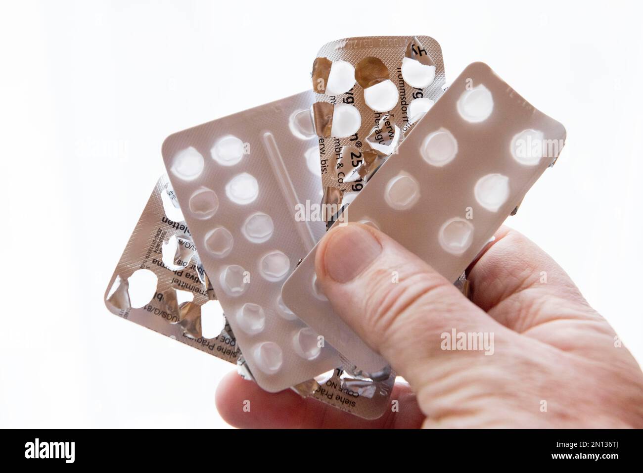 Hand holding blister packs of tablets, tablet addiction Stock Photo - Alamy