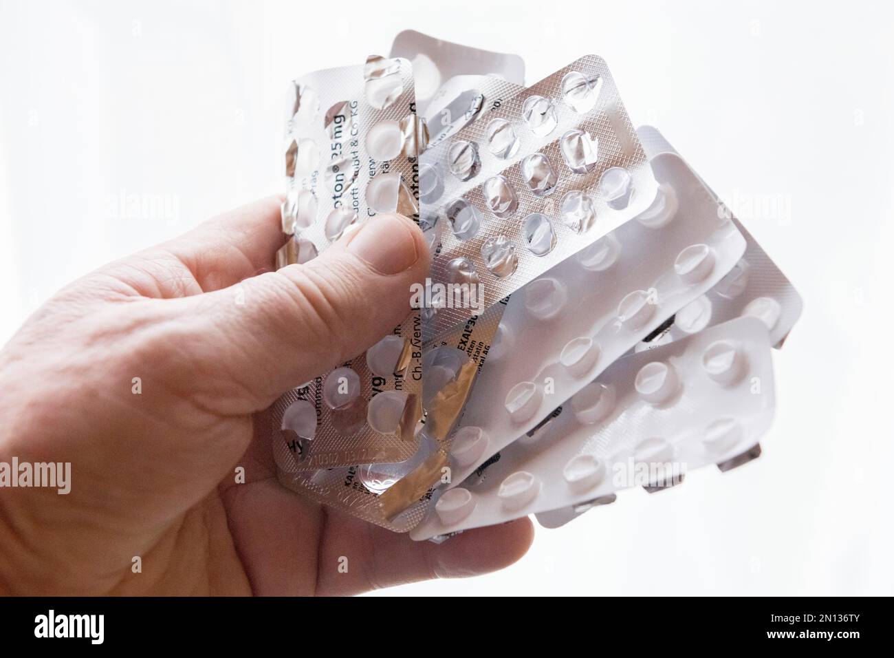 Hand holding blister packs of tablets, tablet addiction Stock Photo - Alamy