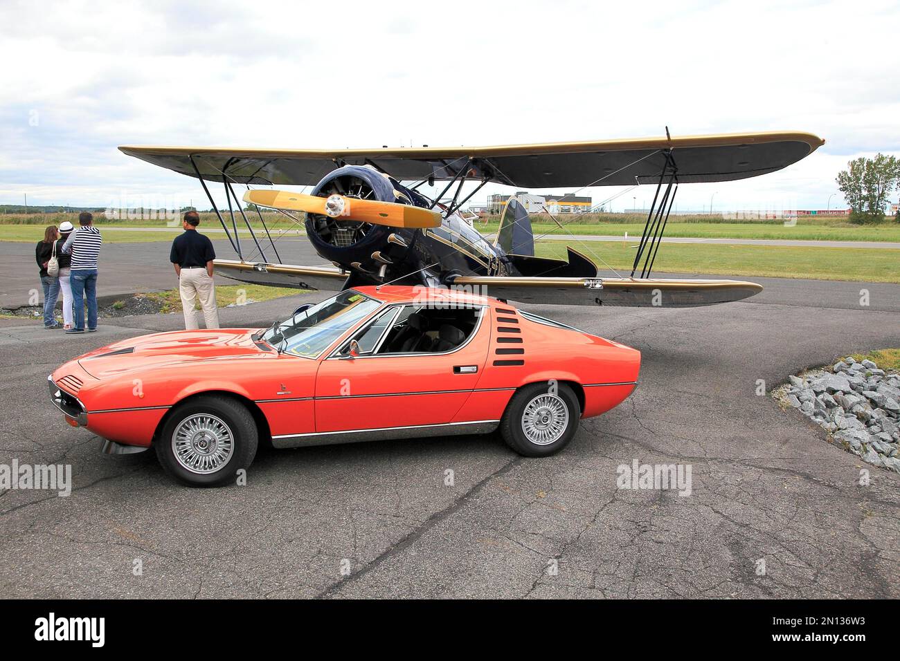 Vintage car, Alfa Romeo Montreal, plane behind, province of Quebec ...