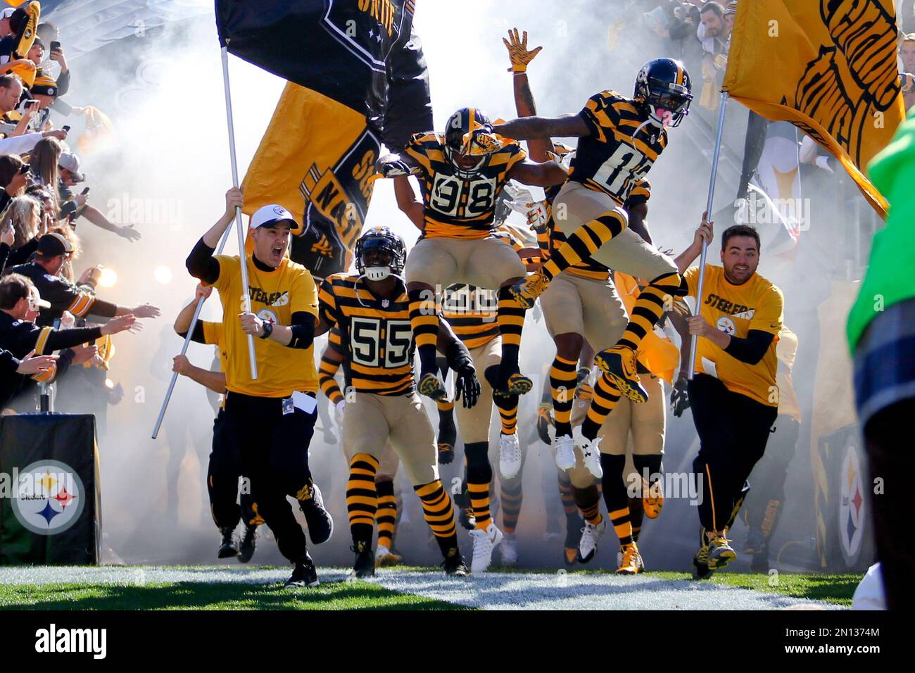The Pittsburgh Steelers leap as they leave the tunnel as the team is ...
