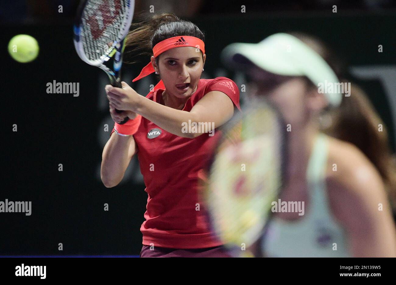 Sania Mirza of India, left, makes a forehand return as she and her ...