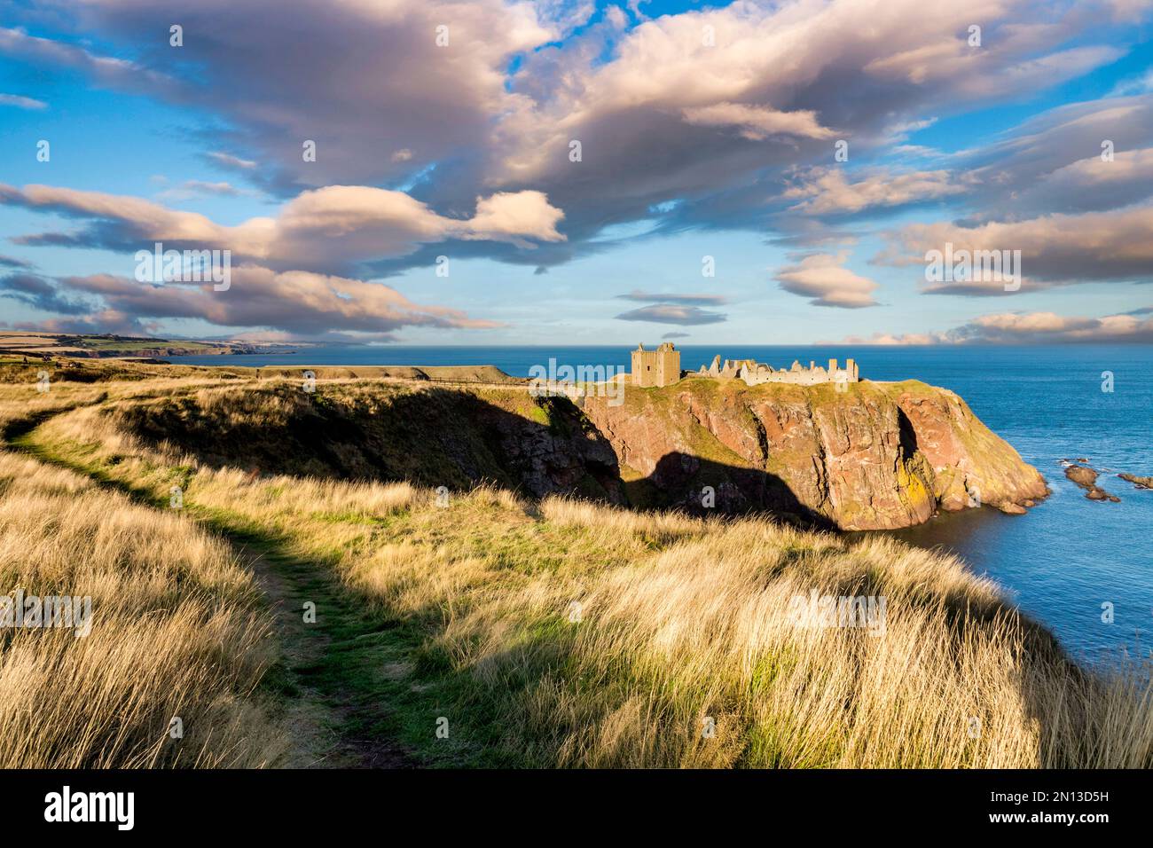 Dunottar Castle, in its position on the cliffs, in evening light, with ...