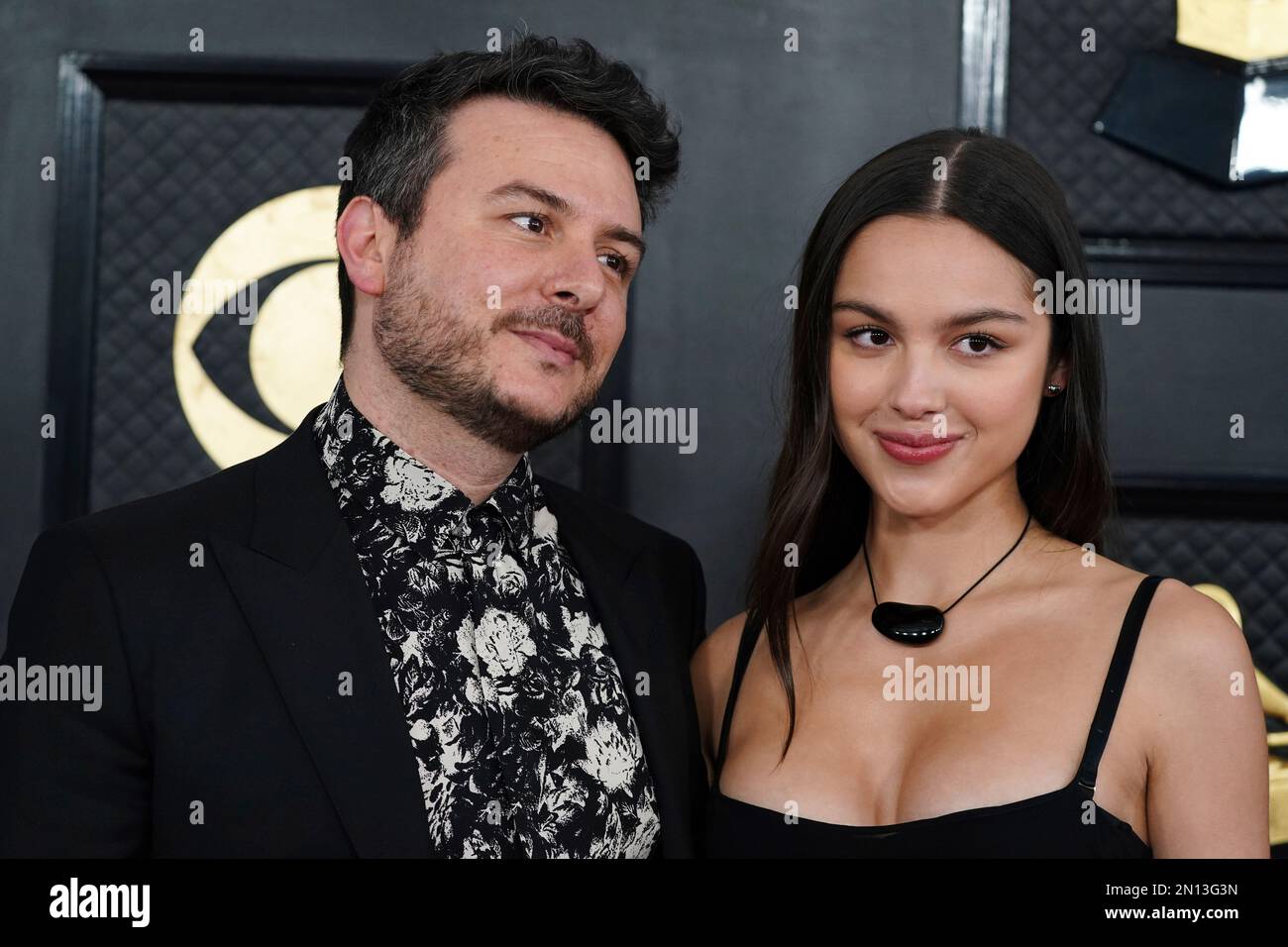 Dan Nigro, left, and Olivia Rodrigo arrive at the 65th annual Grammy ...